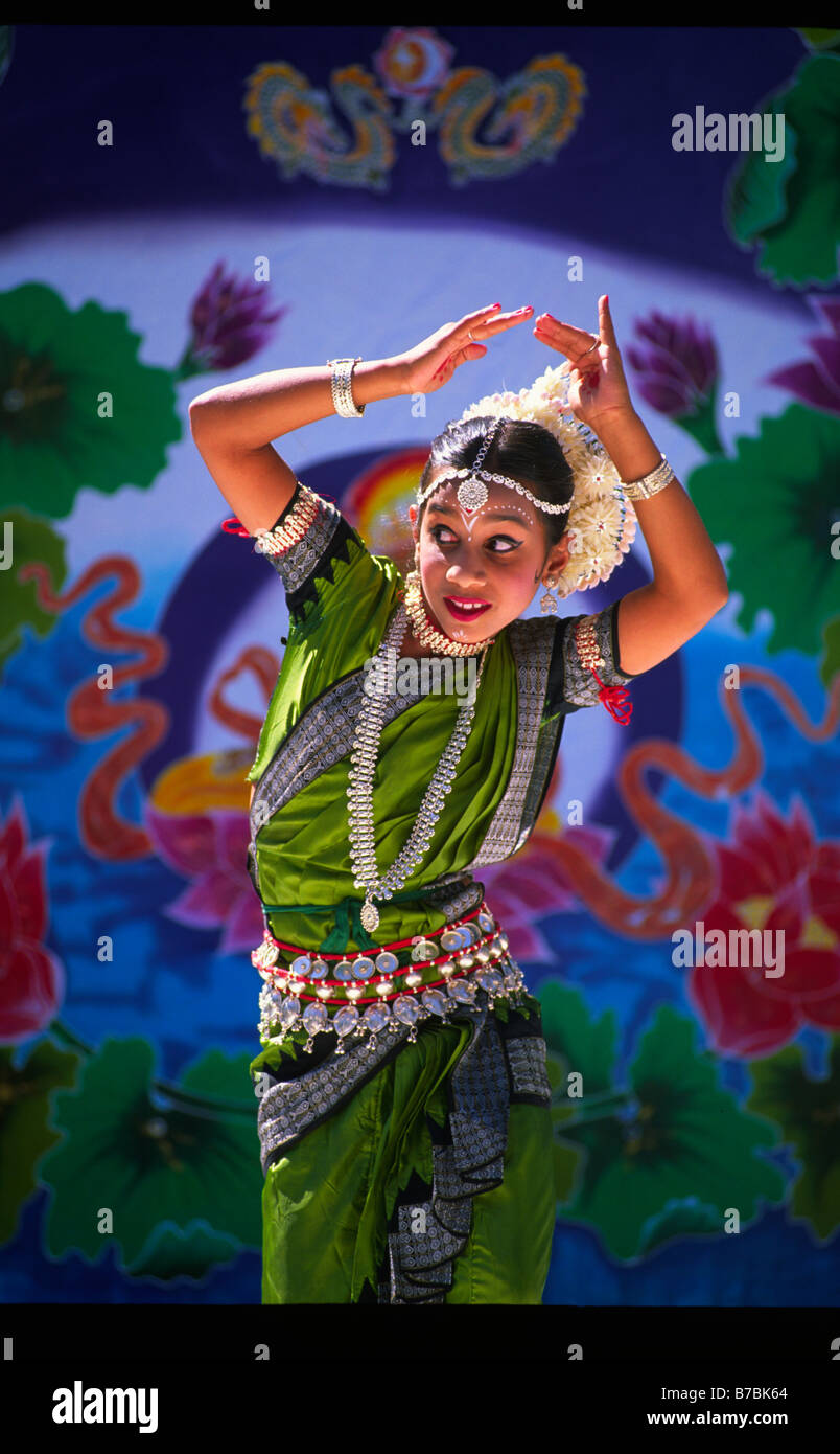 An INDIAN GIRL in a GREEN SARI and traditional JEWELRY performs a ...