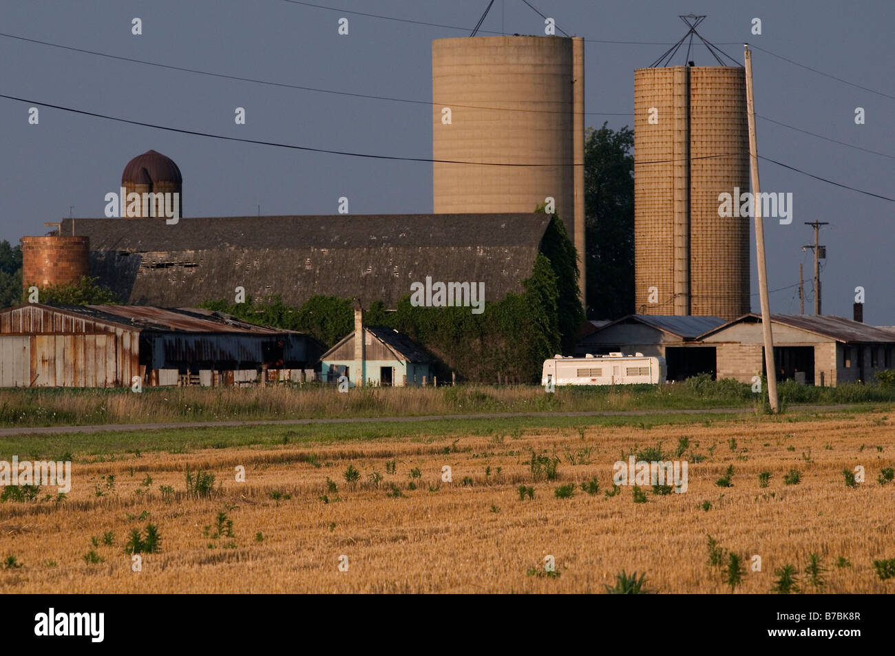 Farm and field at dusk Stock Photo - Alamy