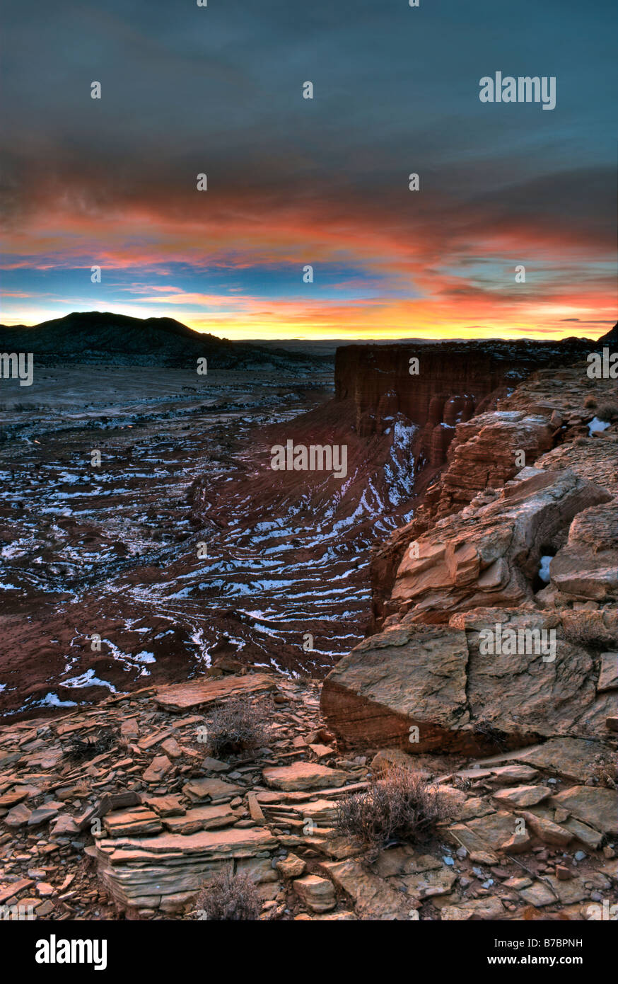 Up top a sandstone cliff looking over the edge at sunset Stock Photo ...