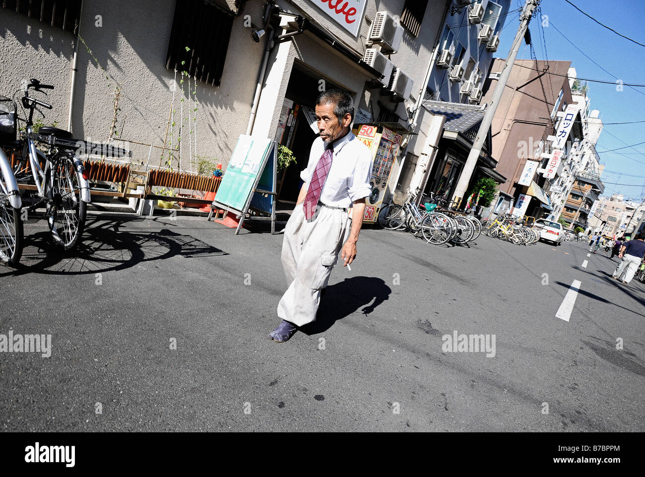 A jobless man wanders through the streets of Kamagaski district in ...