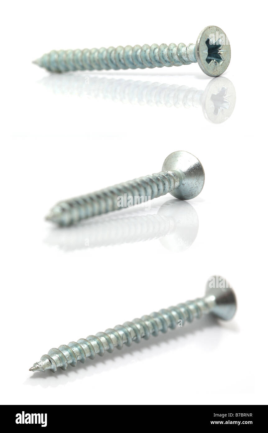 three screws on white with reflection industrial objects Stock Photo ...