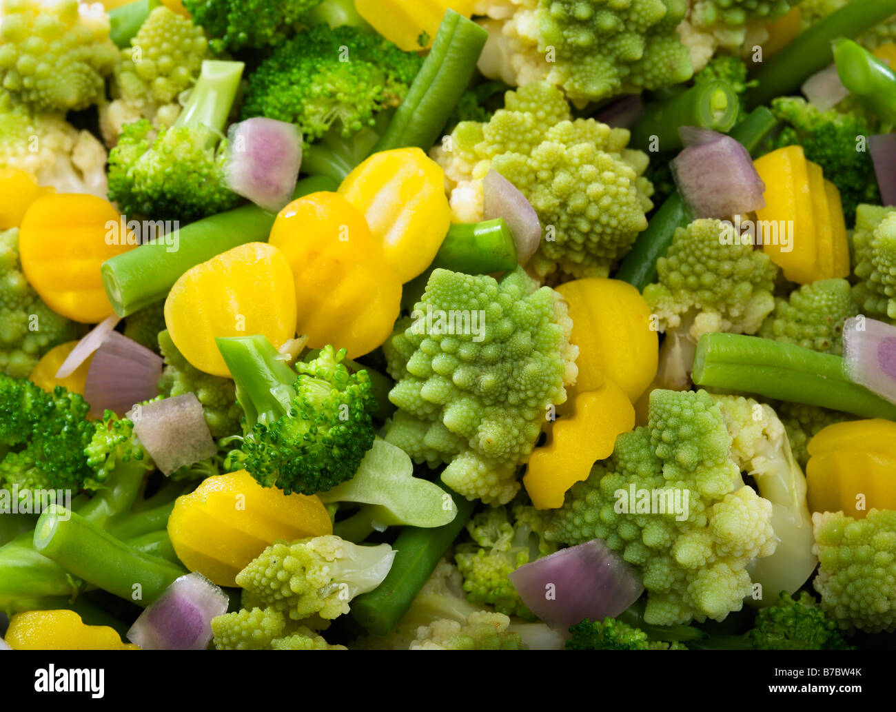 mixed vegetables background consisting of broccoli florets, red onion ...