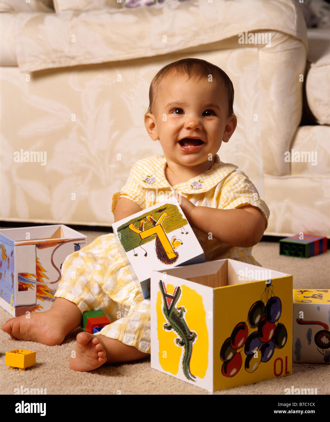 BABY GIRL plays with BLOCKS MR Stock Photo - Alamy