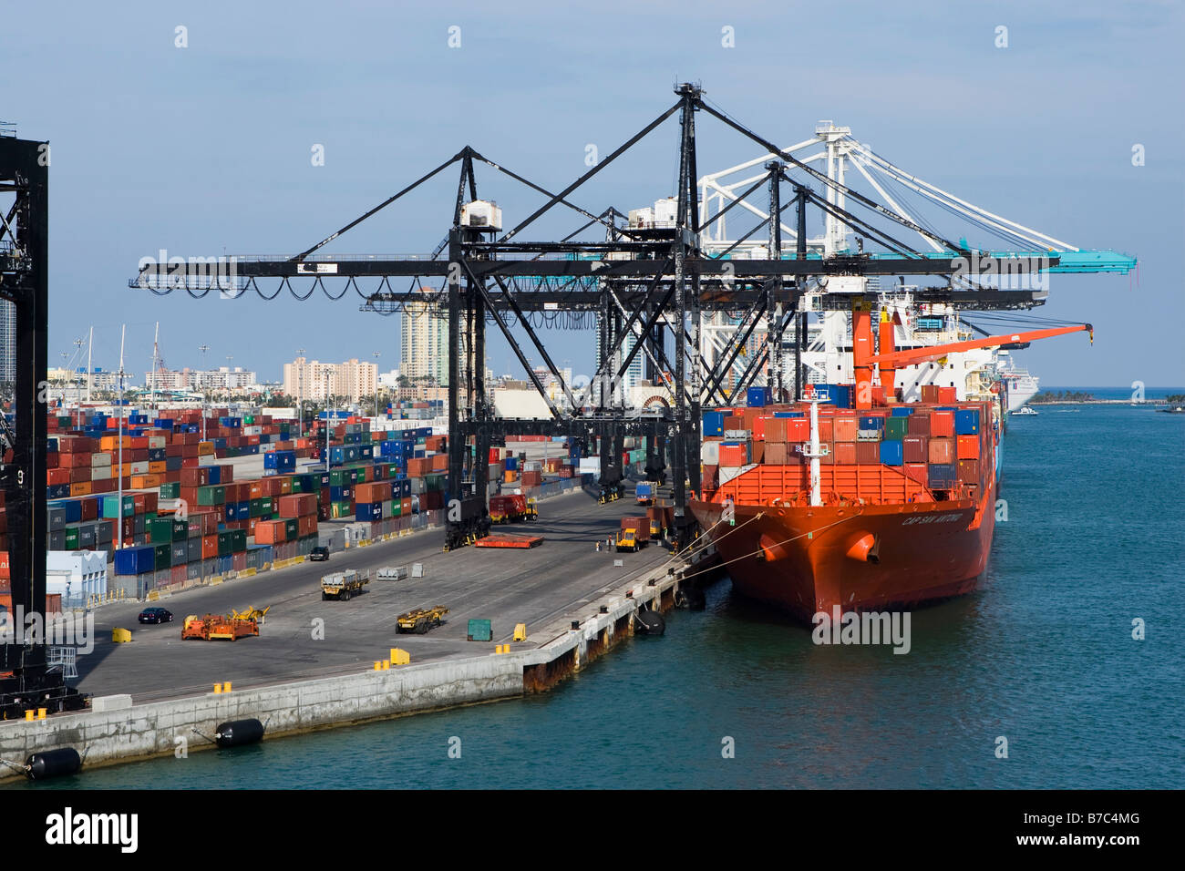 Gantry cranes unload a container ship as it docks in the Port of Miami on Dodge Islando in ...