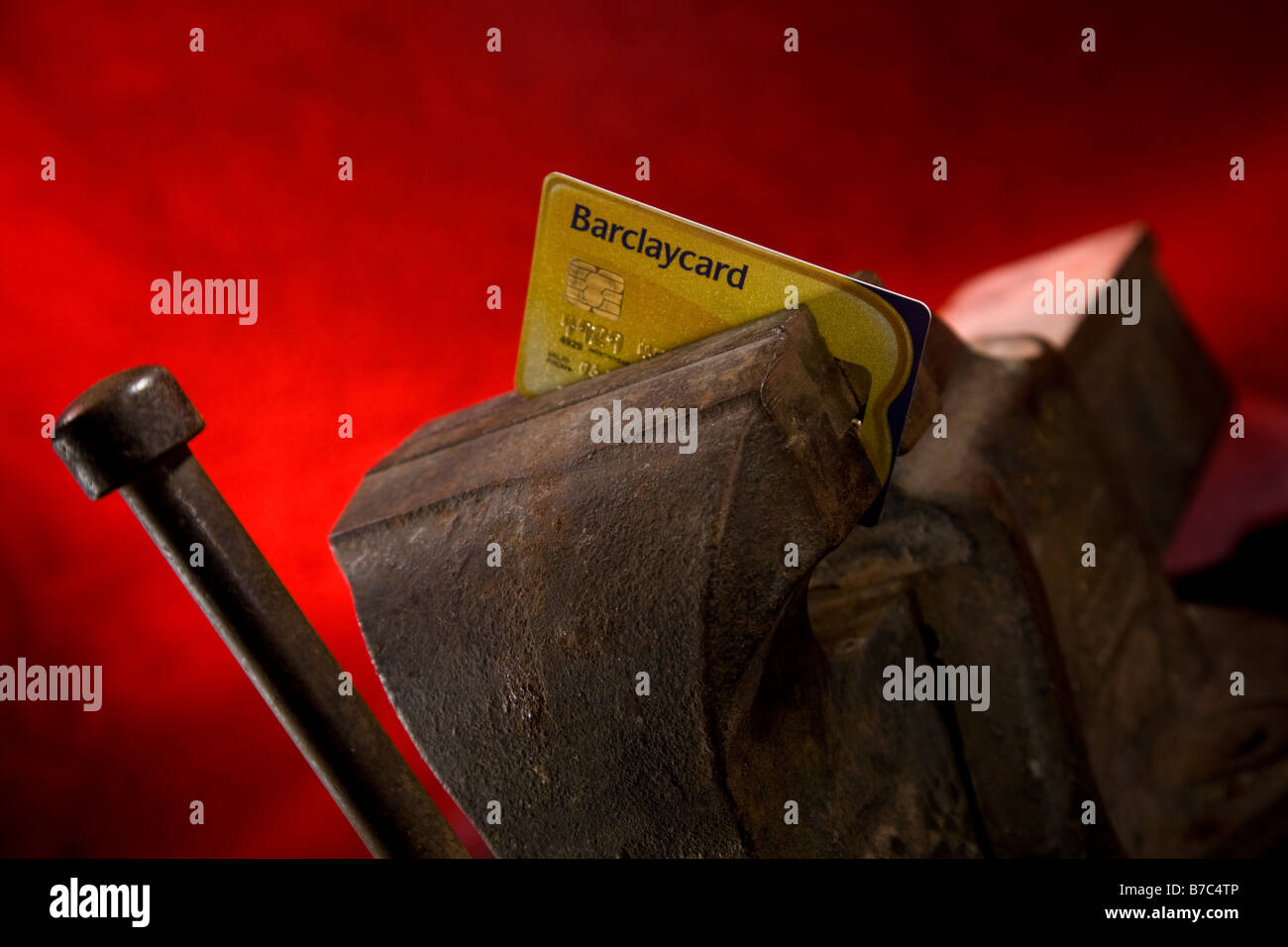 Credit card in vice Stock Photo - Alamy
