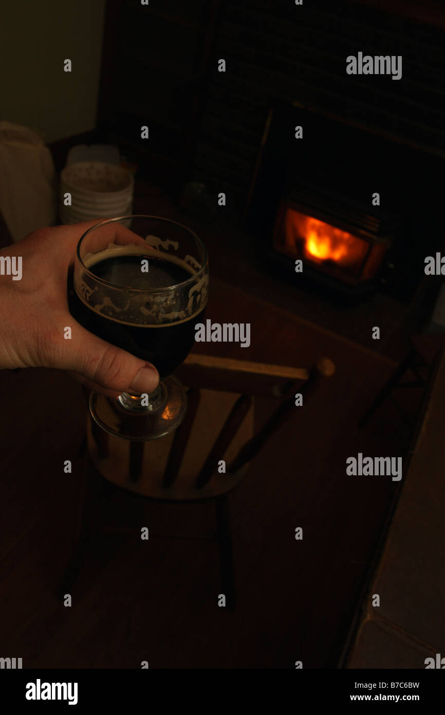 Hand Dark beer fire Stock Photo - Alamy
