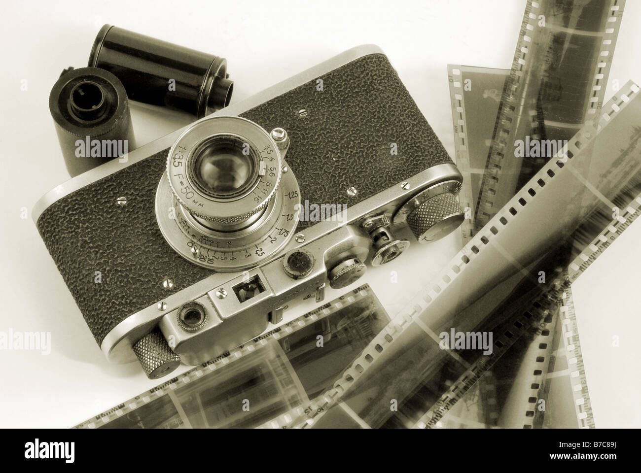 The old film camera with cartridges and strips of a negative film Stock ...