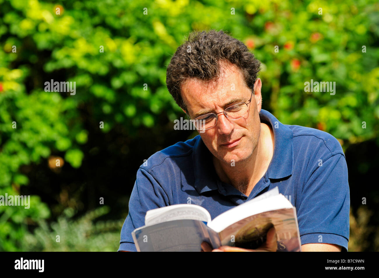 Attractive man reading book hi-res stock photography and images - Alamy