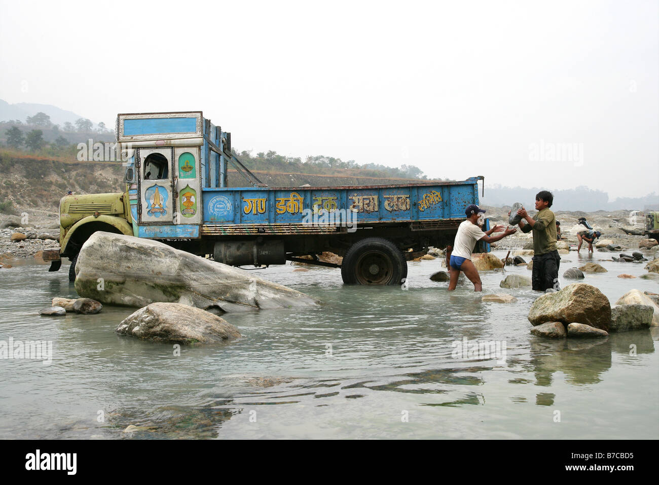 “Men hand quarrying stone on the Seti River nepal” Stock Photo - Alamy
