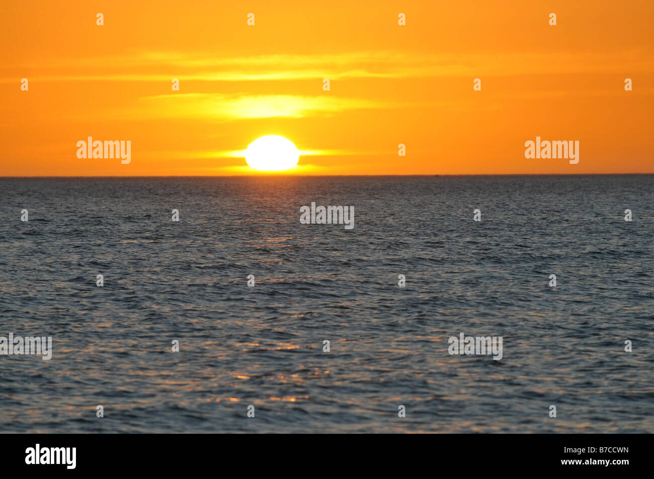 Sunset by the ocean Stock Photo - Alamy