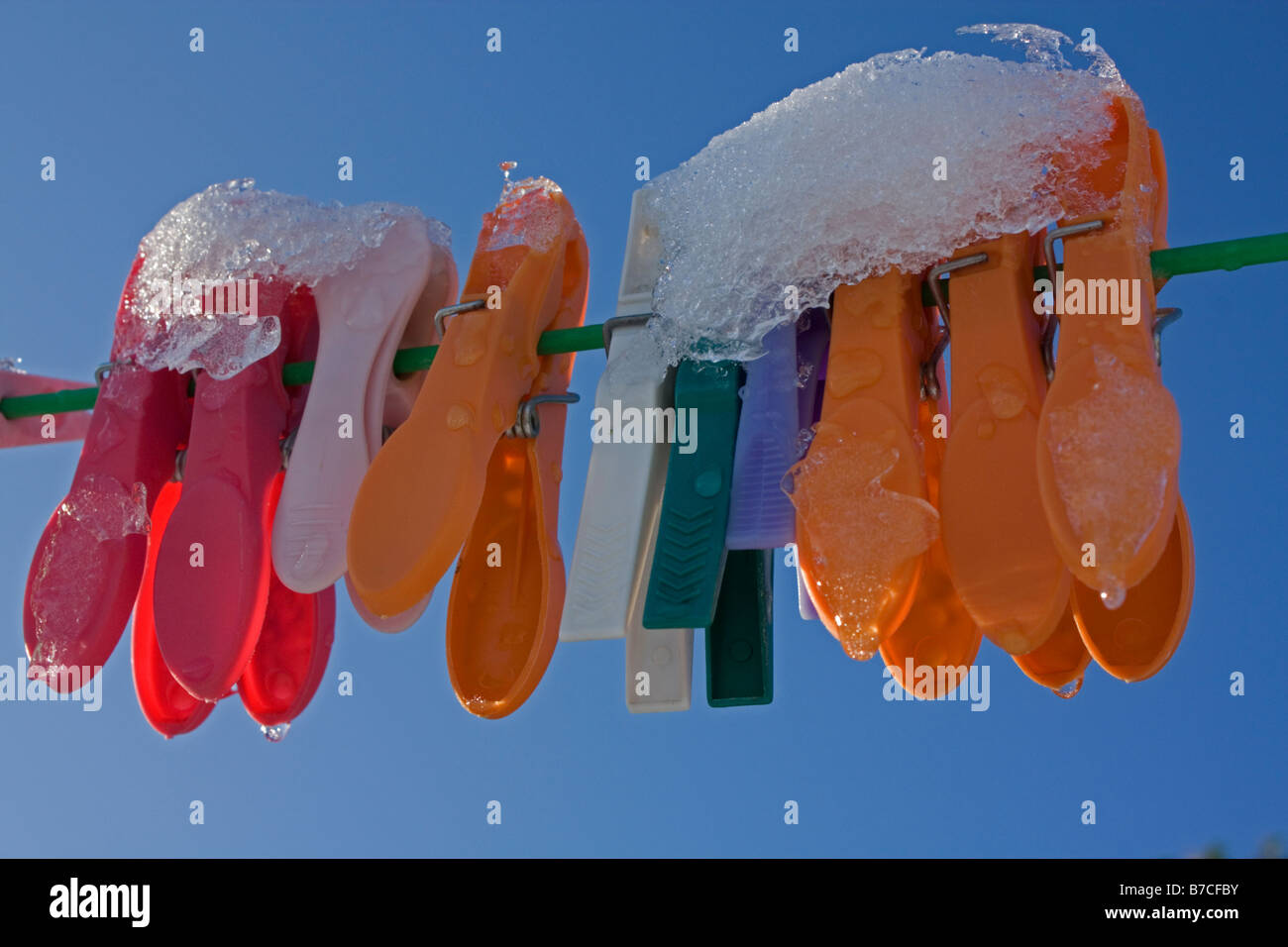 Pegs on washing line covered in snow UK Stock Photo - Alamy