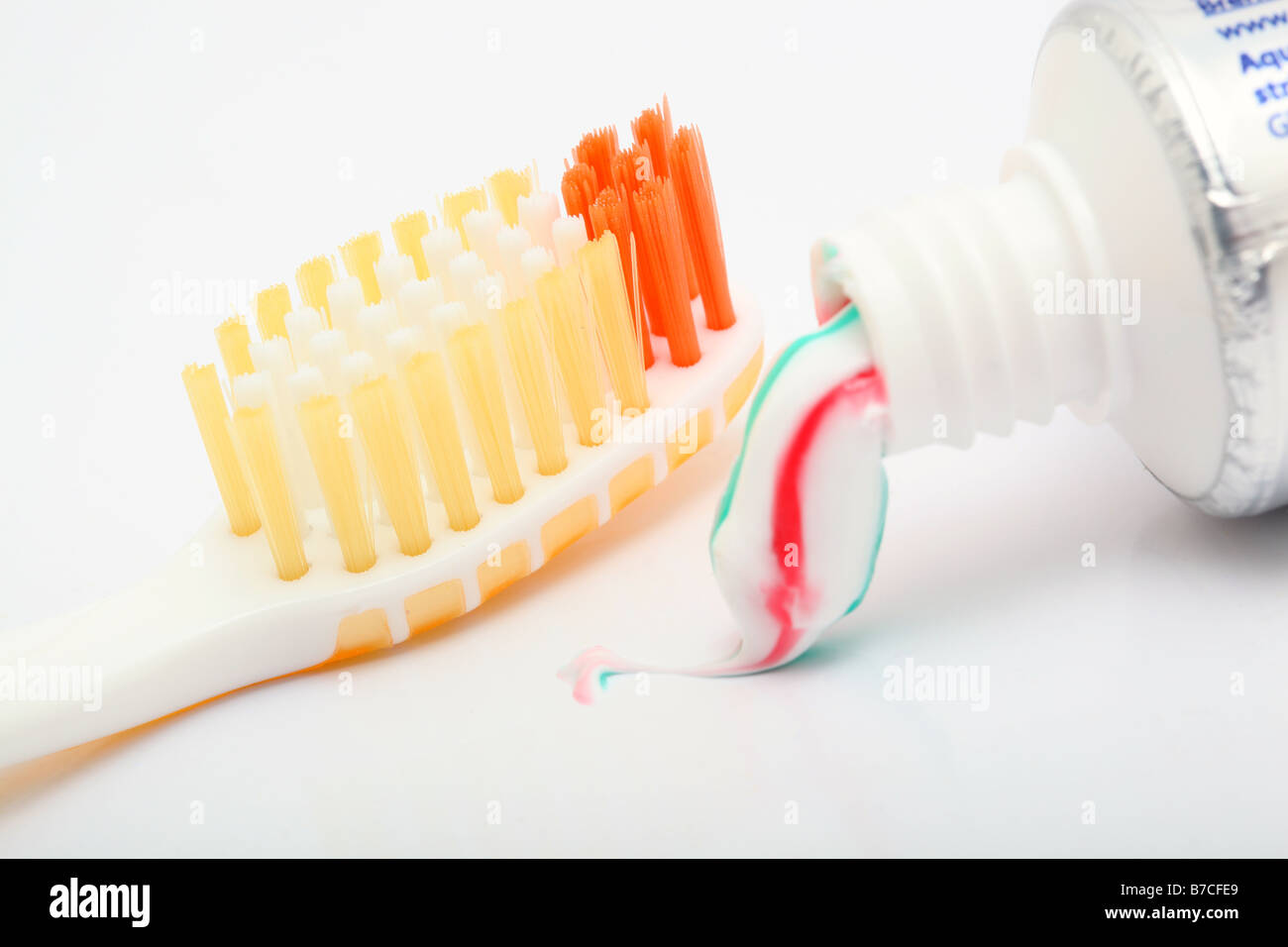 dental hygiene yellow toobrush and toothpaste detail Stock Photo - Alamy