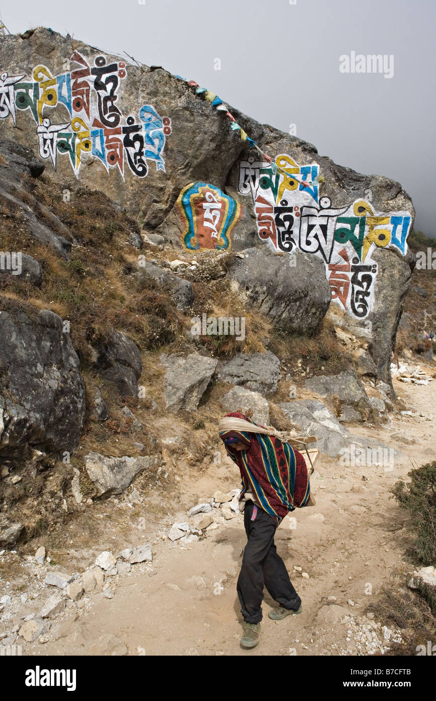 A living faith mantras or sacred syllables being painted on a boulder ...