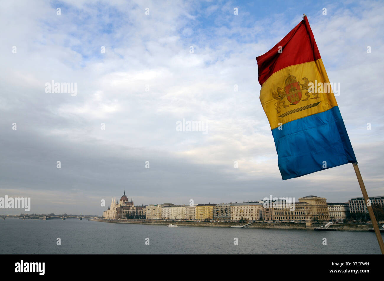 A city flag flying from one of Budapest's bridge over the Danube river ...