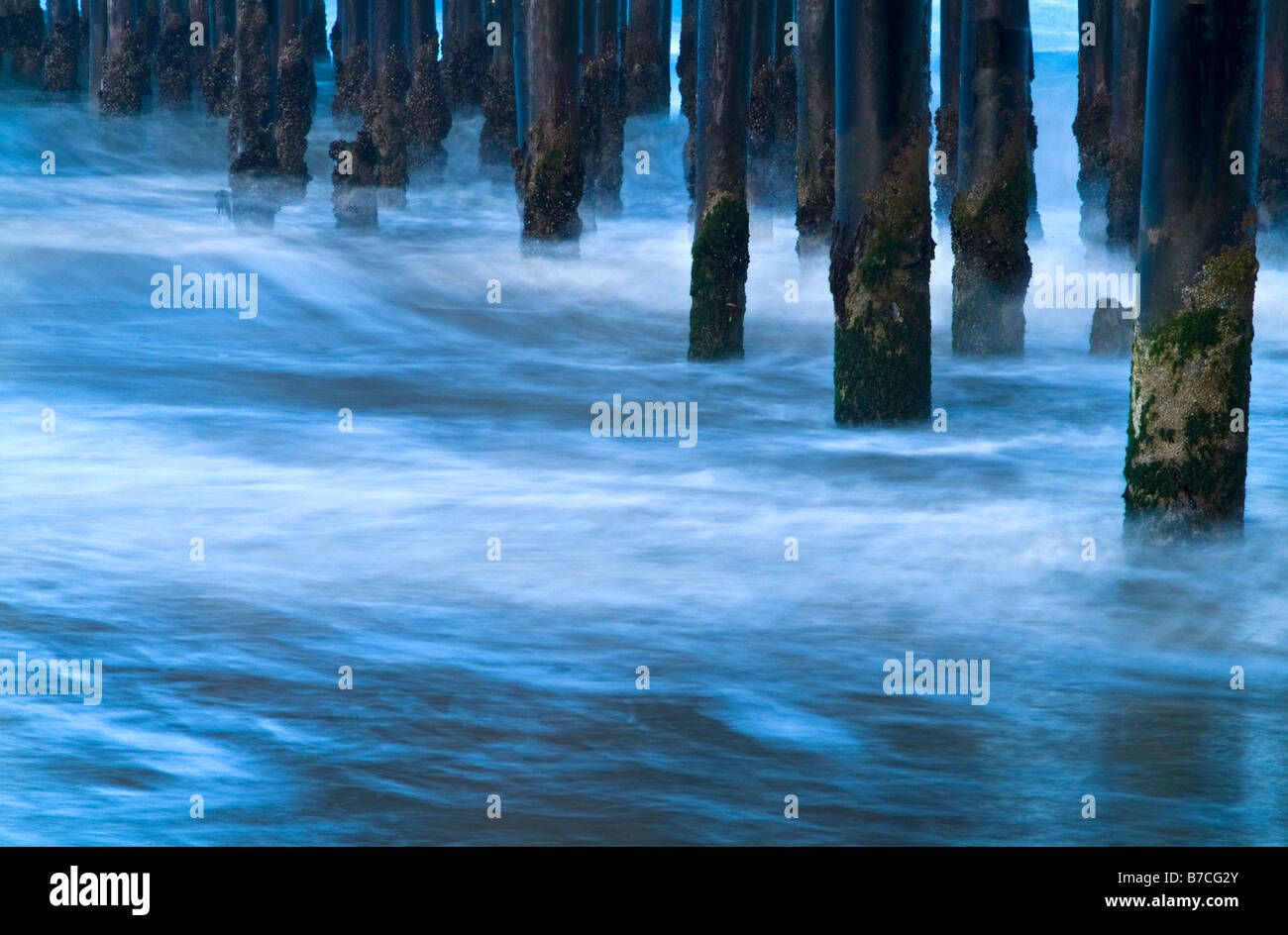 Ocean Waves Blur With Pier Pilings Stock Photo - Alamy