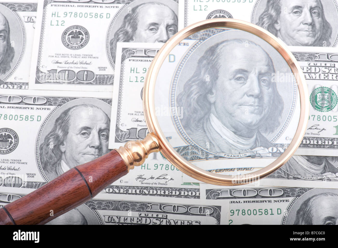 object on white currency magnifying glass with money Stock Photo - Alamy