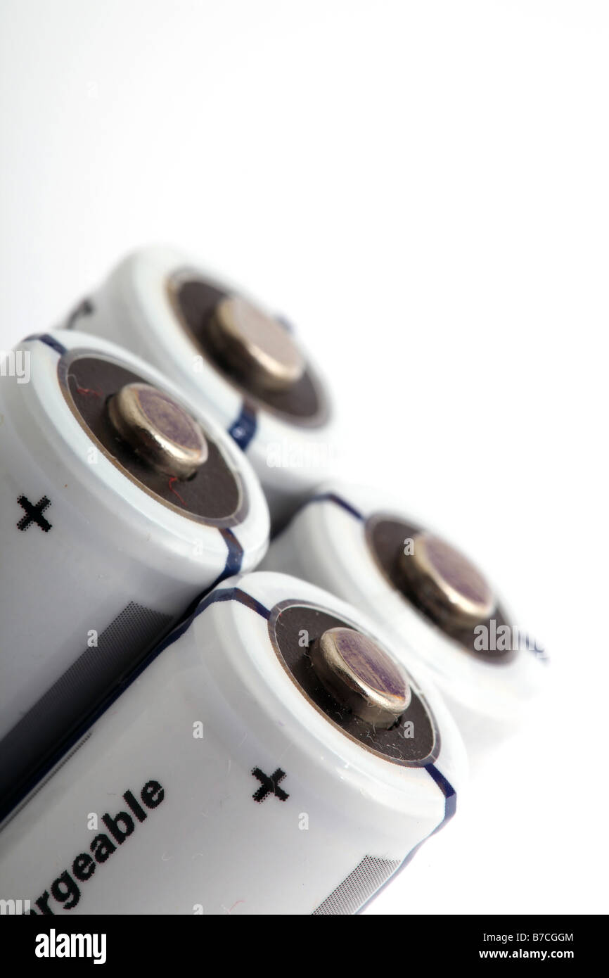four white rechargeable batteries on white background with copyspace ...