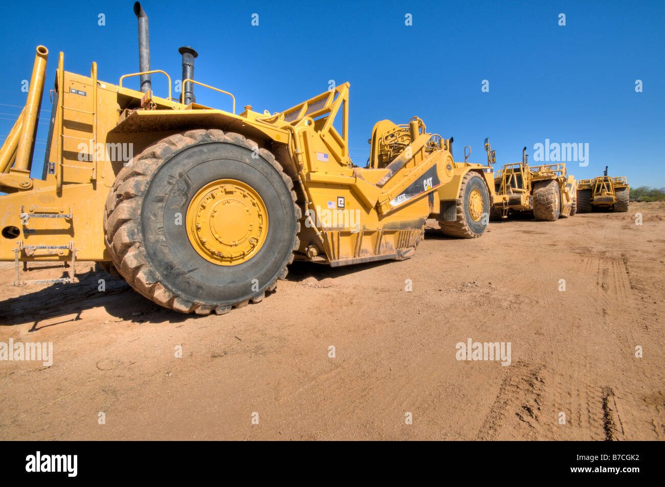 Four parked heavy scrapers Stock Photo - Alamy