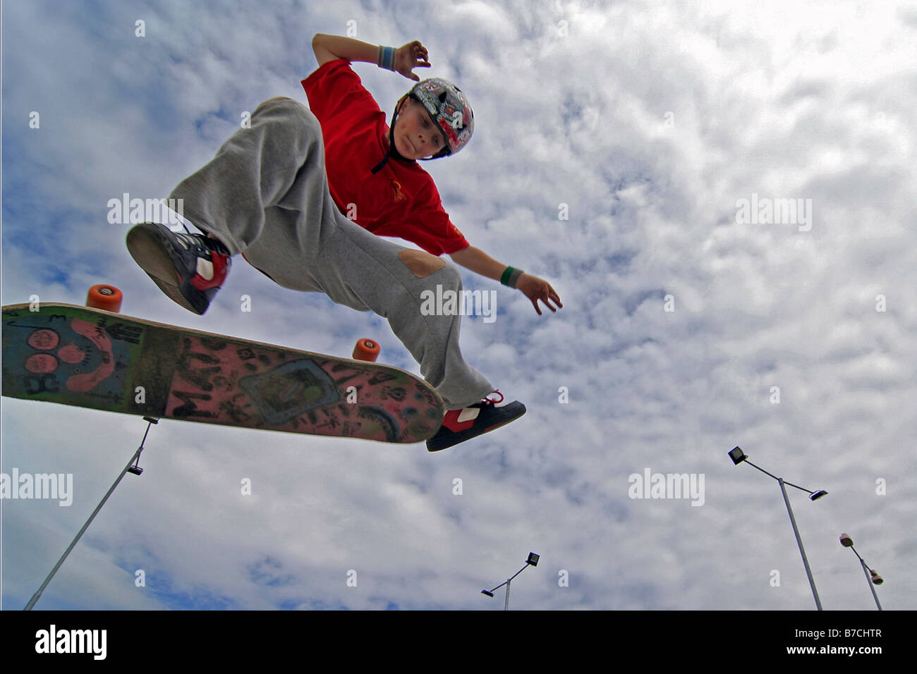 Young boy jumping on skateboard Stock Photo - Alamy