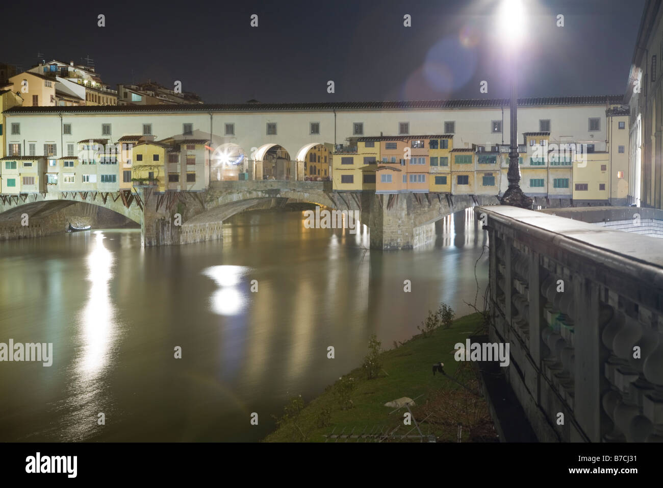 The gold market bridge over the River Arno in Florence, Italy at night ...