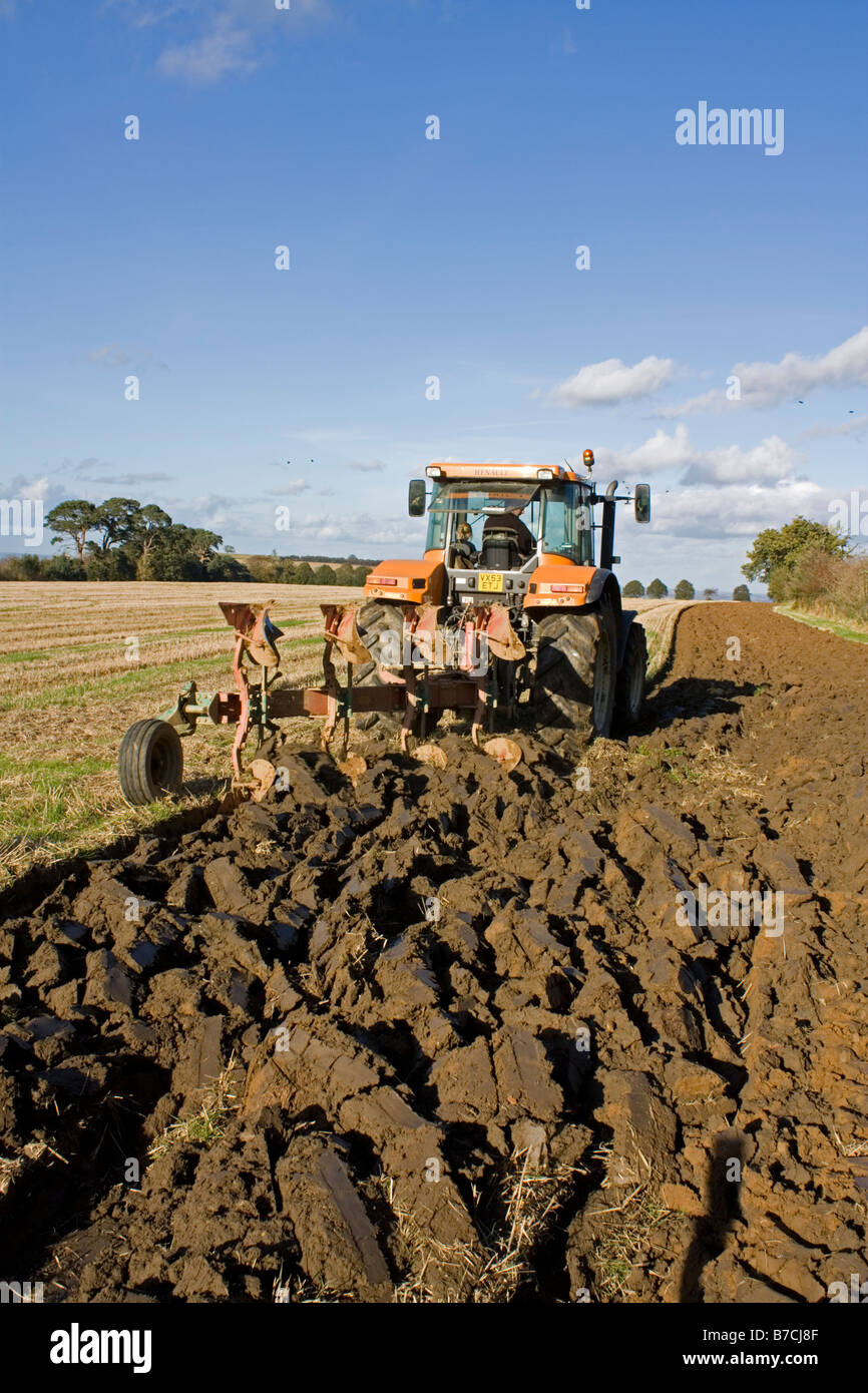 Farmer ploughing field UK Stock Photo - Alamy