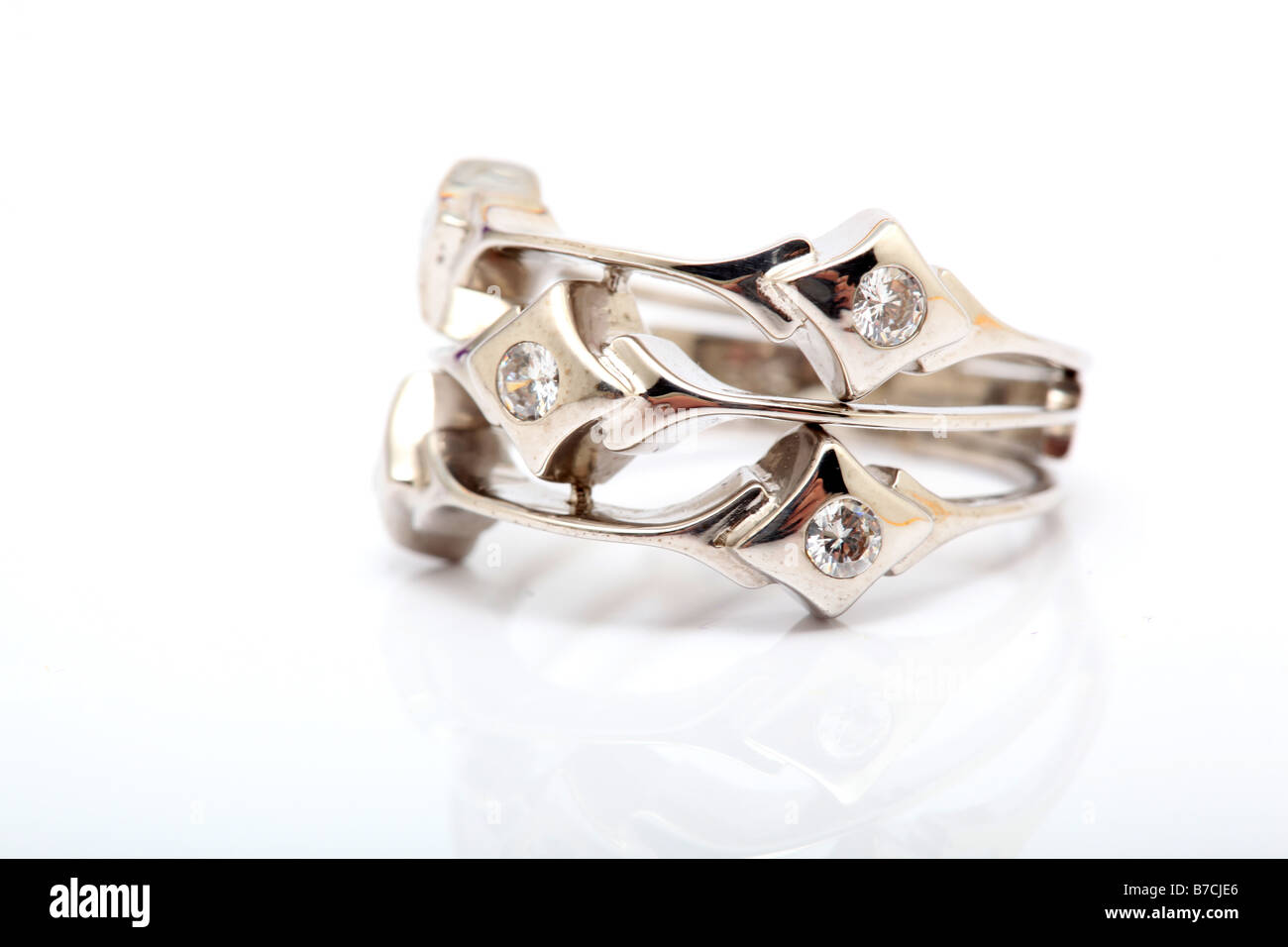 closeup white gold ring with gem stones isolated and reflected Stock ...