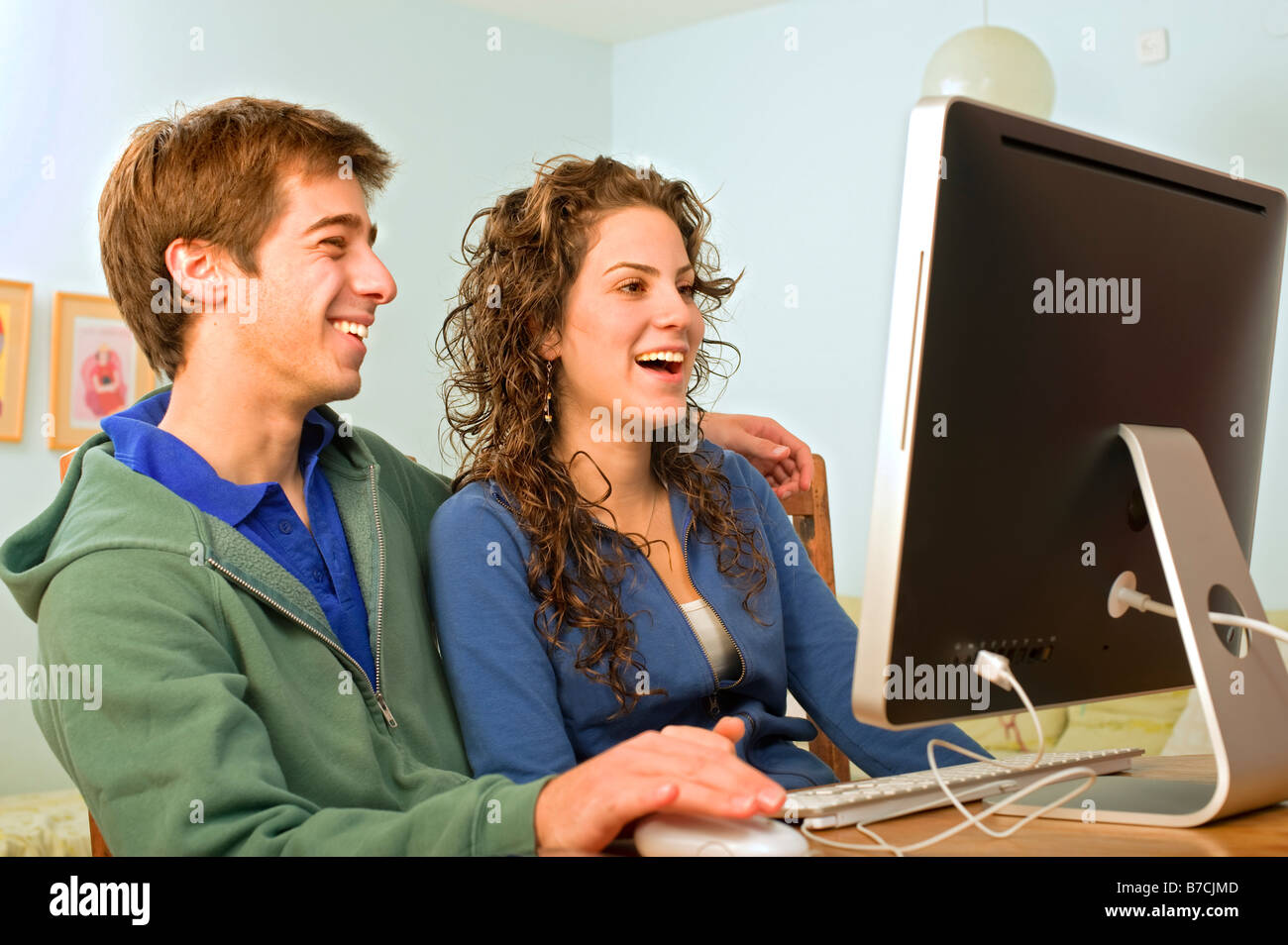 teenager couple having fun with the computer Stock Photo - Alamy