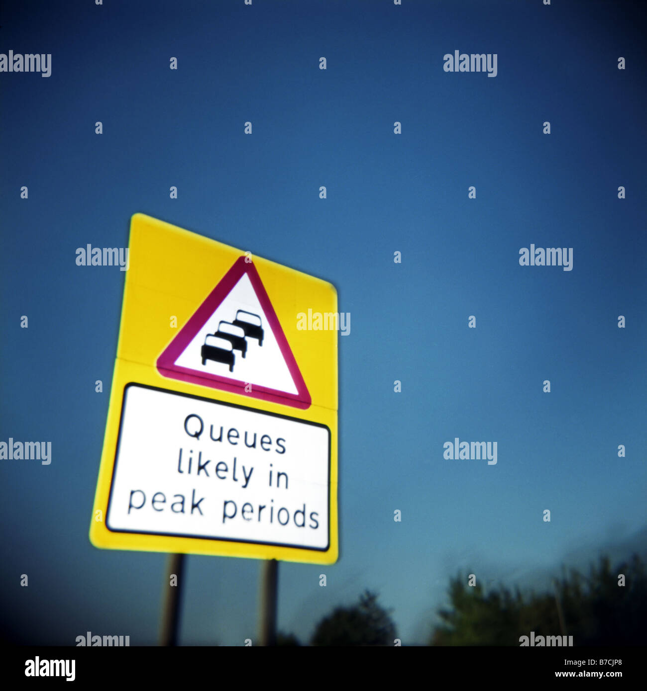 A Queues Likely in peak periods sign, traffic congestion warning Stock ...