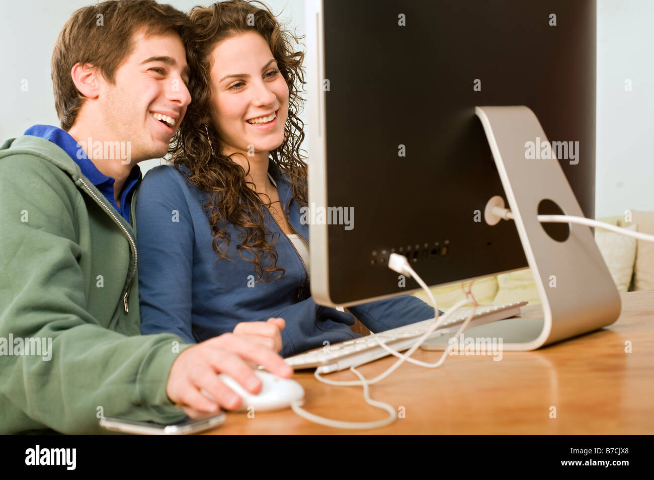 teenager couple having fun with the computer Stock Photo - Alamy