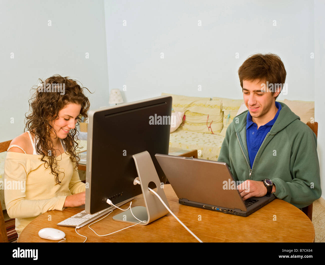 teenager couple having fun with the computer Stock Photo - Alamy