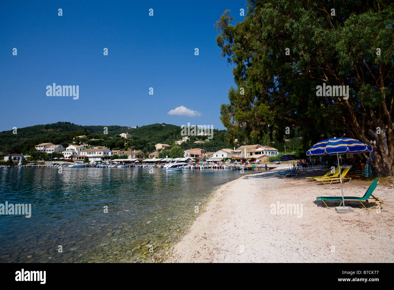 The beach and little harbour at Agios Stefanos in Corfu Stock Photo - Alamy