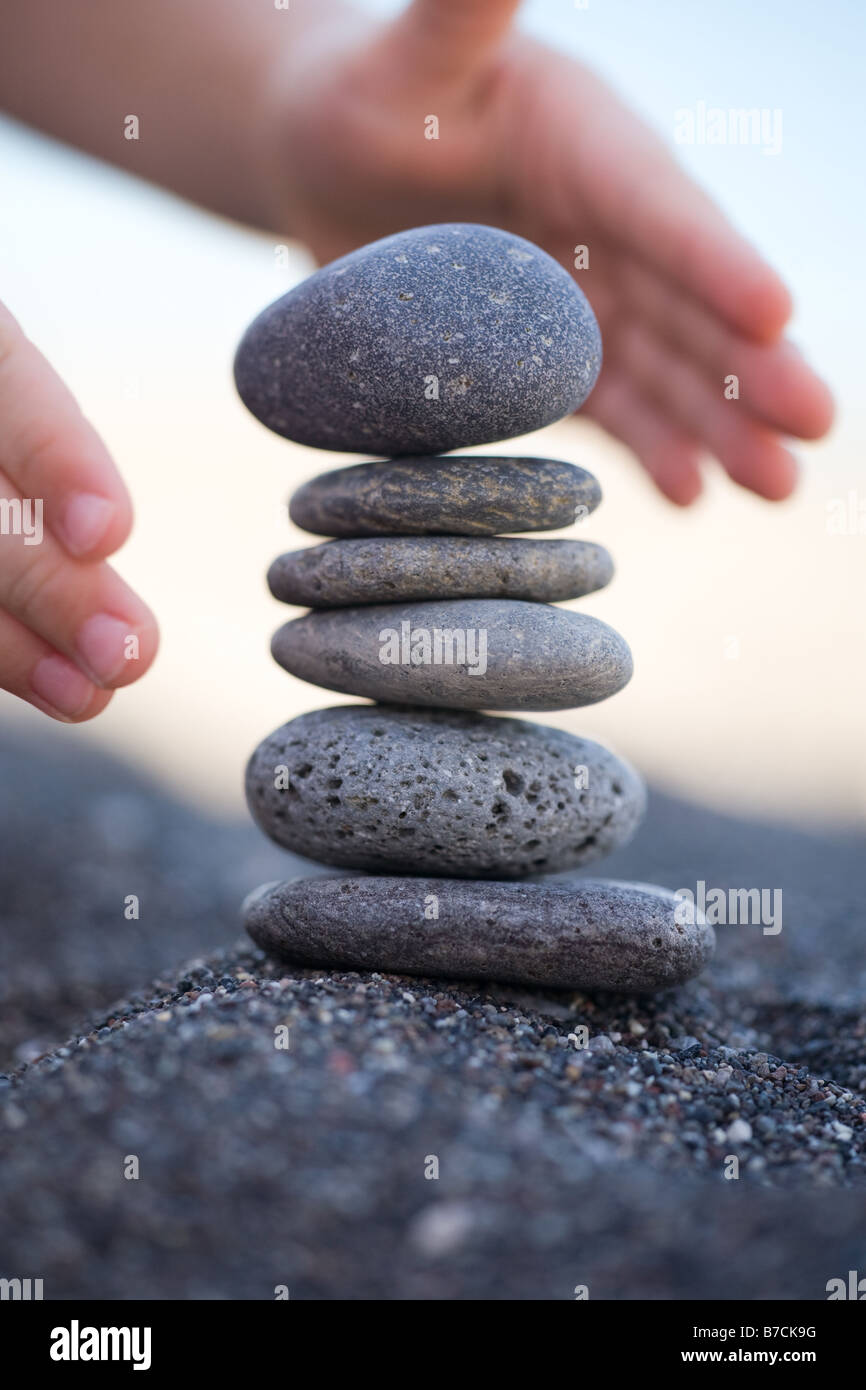 Balanced Stones. Stack of volcanic pebbles on seashore Stock Photo - Alamy