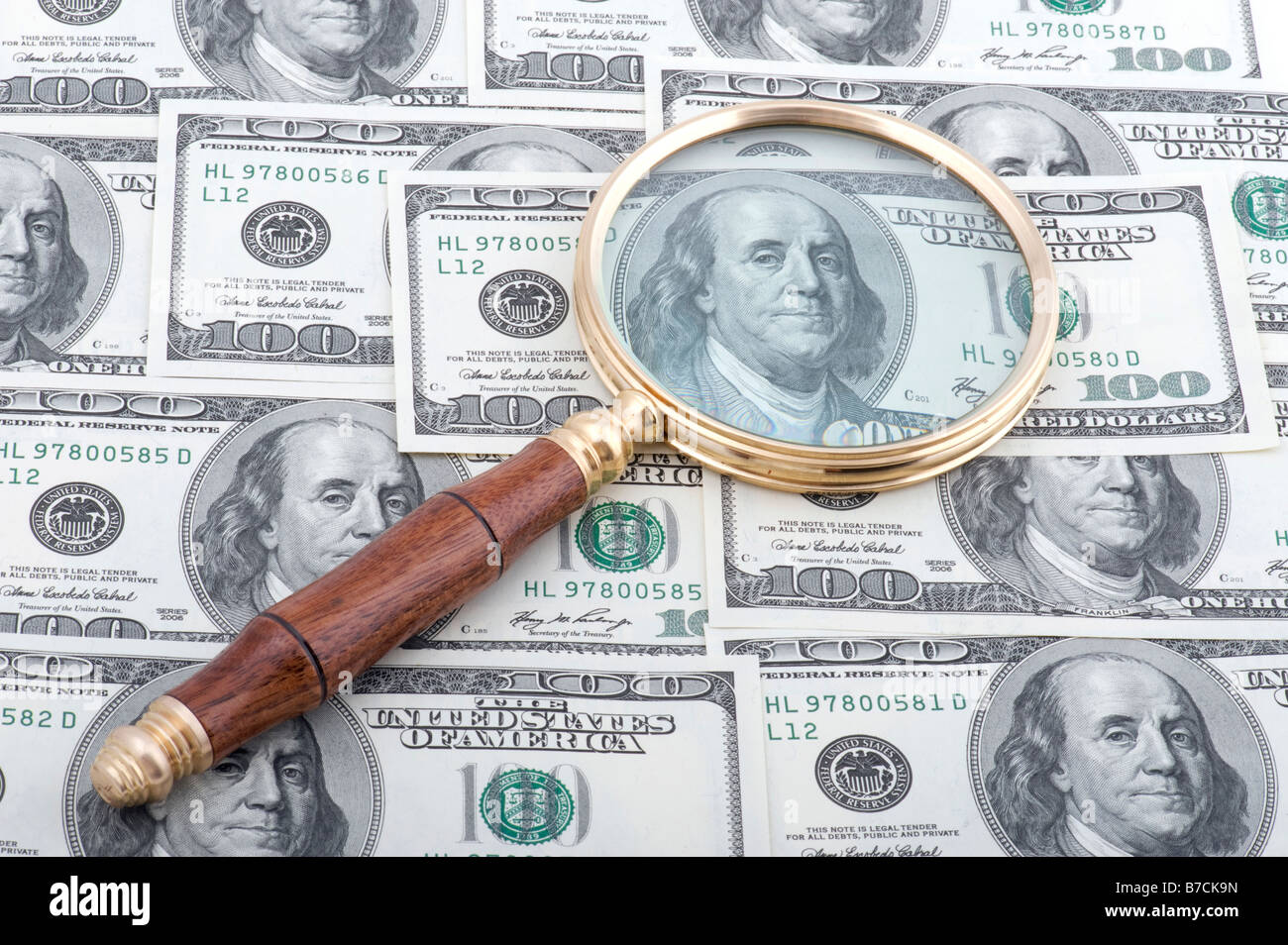 object on white currency magnifying glass with money Stock Photo - Alamy