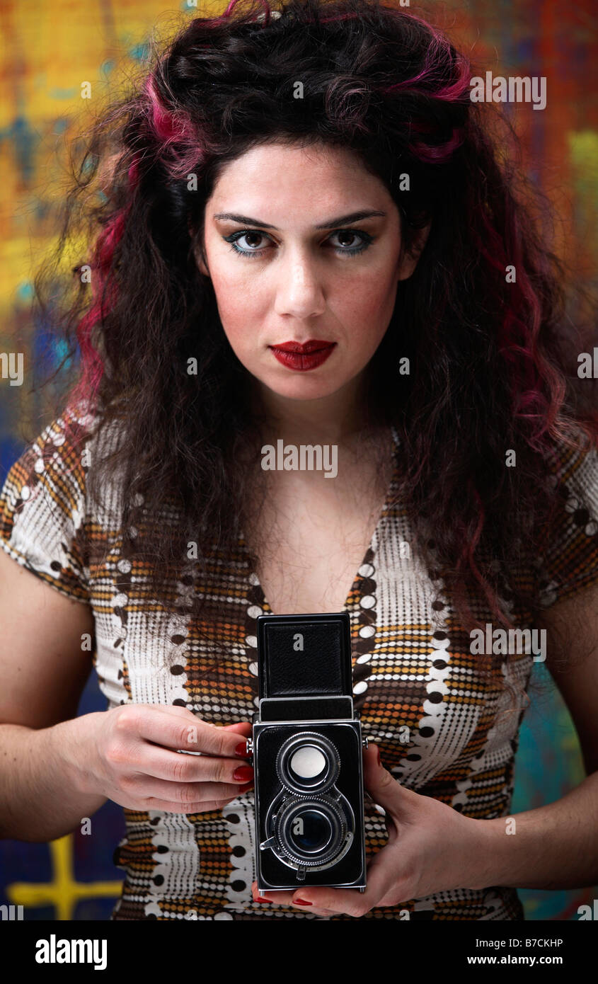 photographer holding a retro tlr camera in hand Stock Photo - Alamy