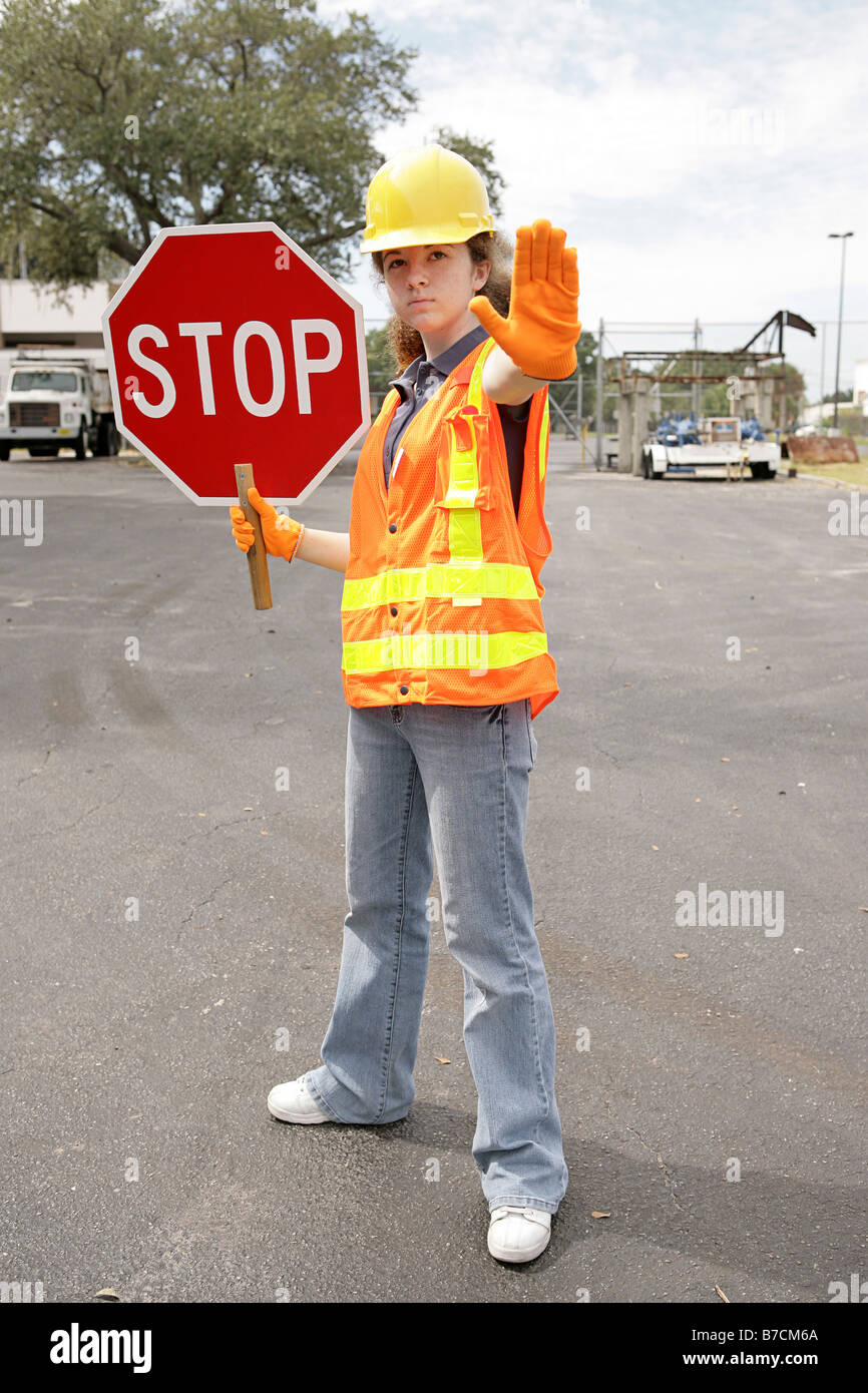 Worker stop sign woman female hard hat safety vest hi-res stock ...