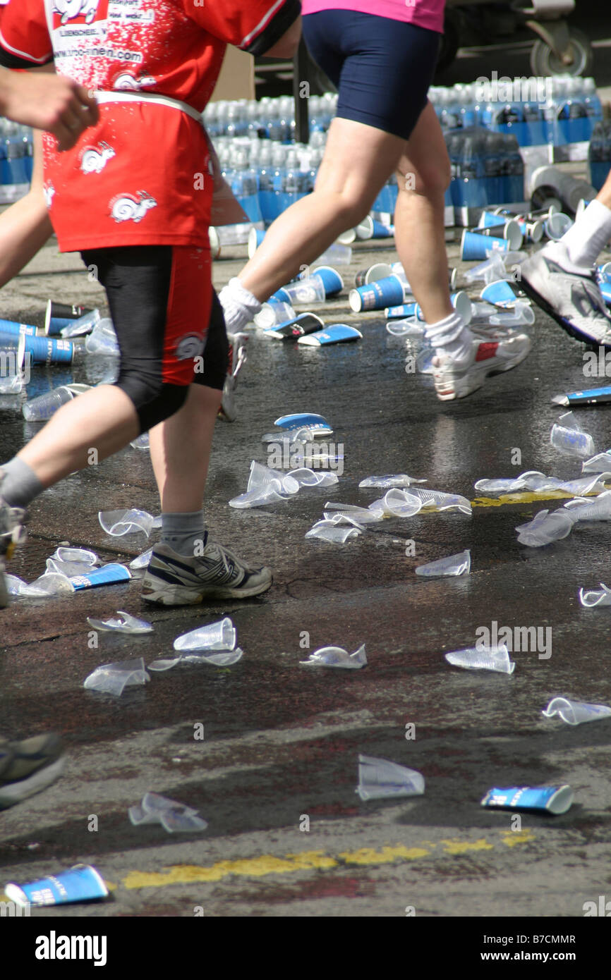 marathon runners between empty drinking cups Stock Photo - Alamy