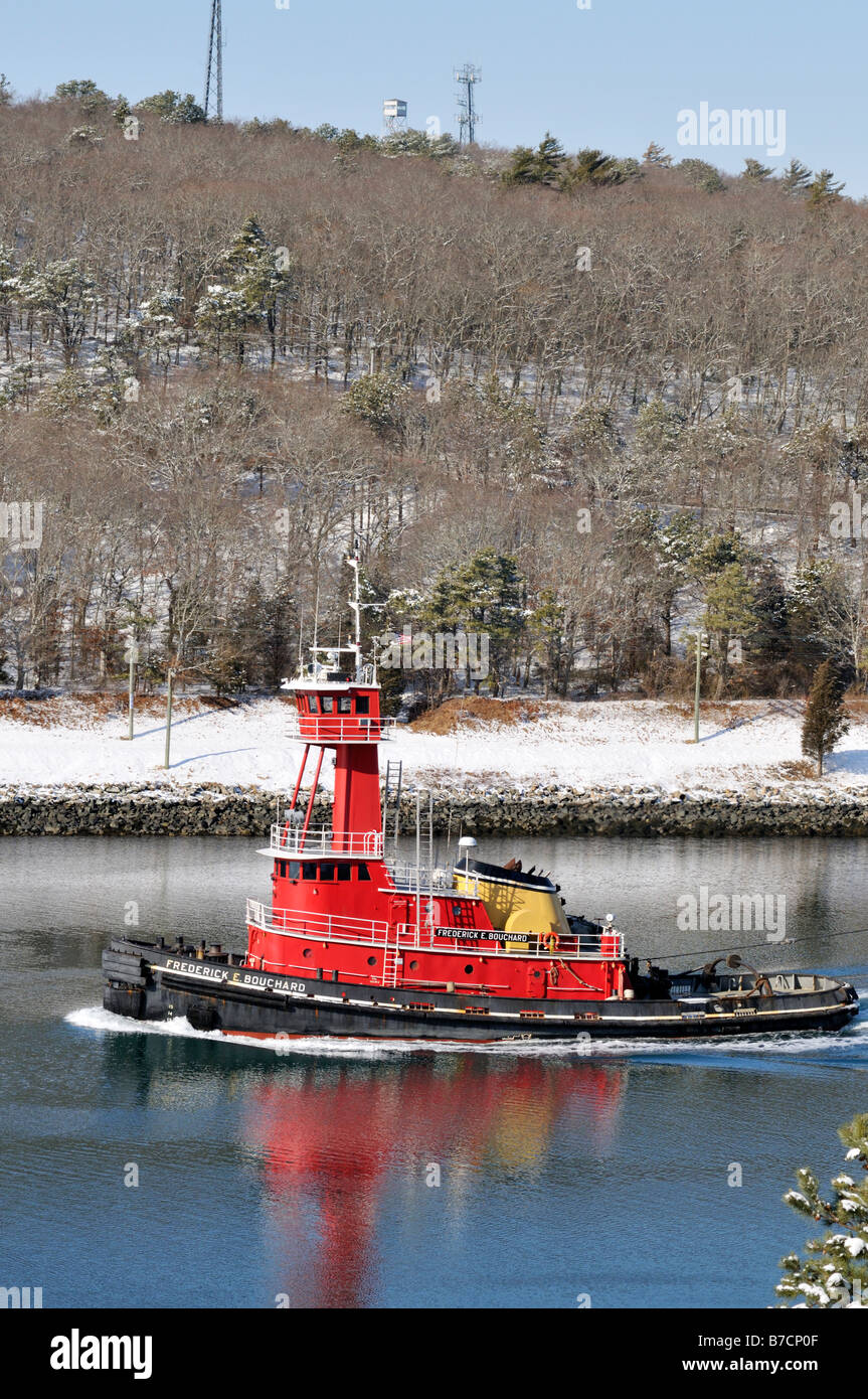 Red tugboat underway in winter waters with snow and trees Stock Photo ...