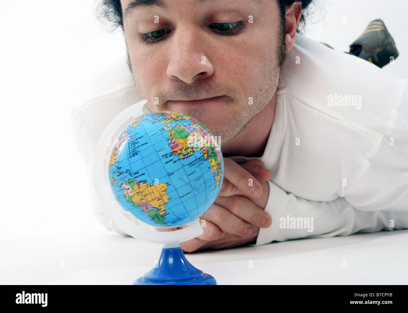 young man with globe Stock Photo - Alamy