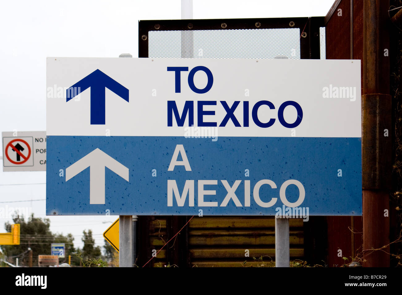 Blue and white sign at Arizona and Mexico border pointing to Mexico ...