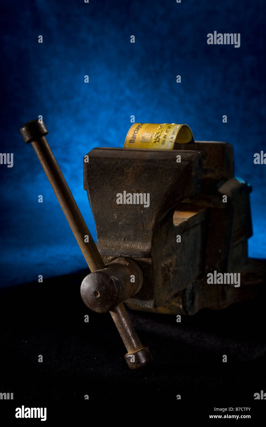 Credit card in vice Stock Photo - Alamy