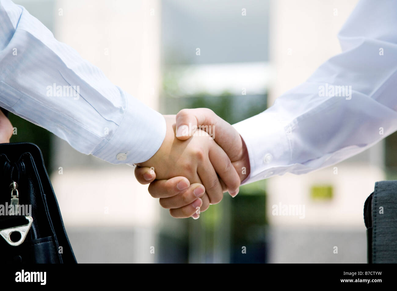 Close up of two business men shaking hands Stock Photo - Alamy