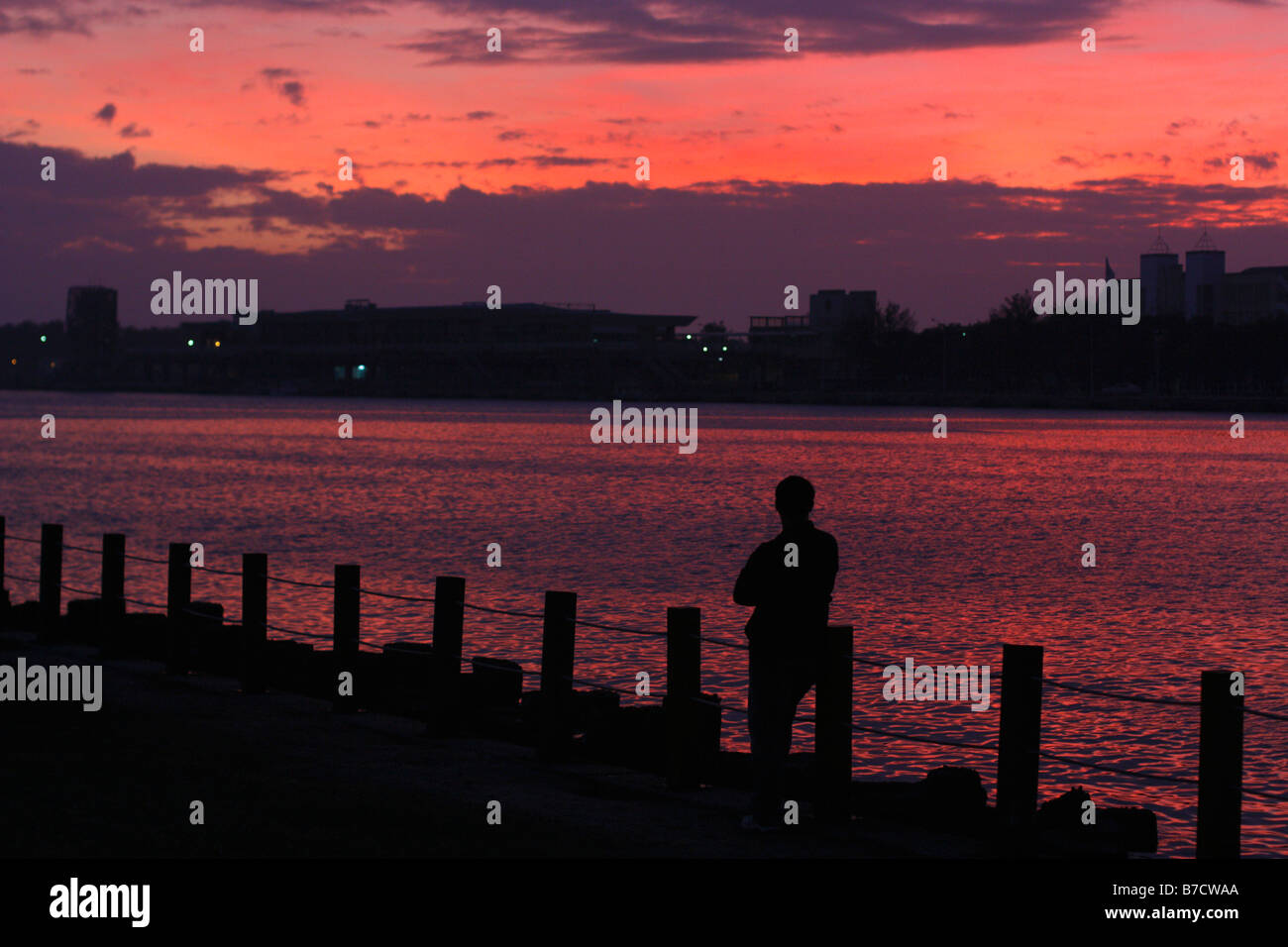 Silhouette of a man watching the sunset at Anping Harbor. Tainan ...