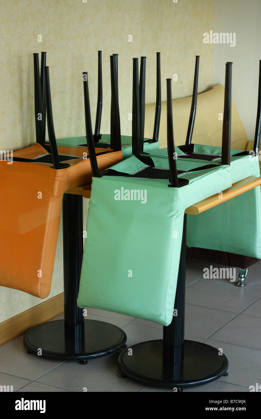 Restaurant chairs upside down on table Stock Photo - Alamy