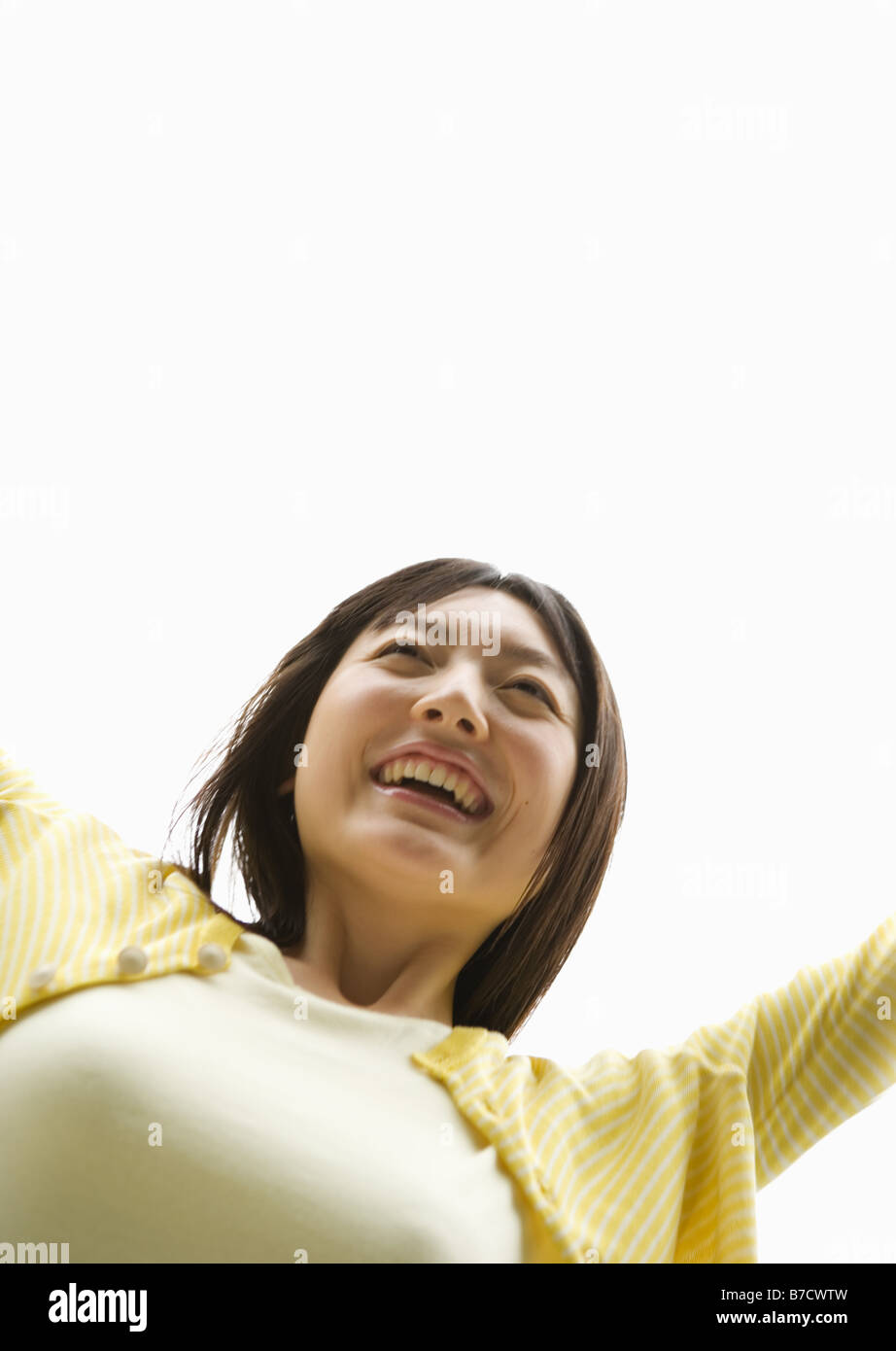 Smiling girls with arms raised Stock Photo - Alamy