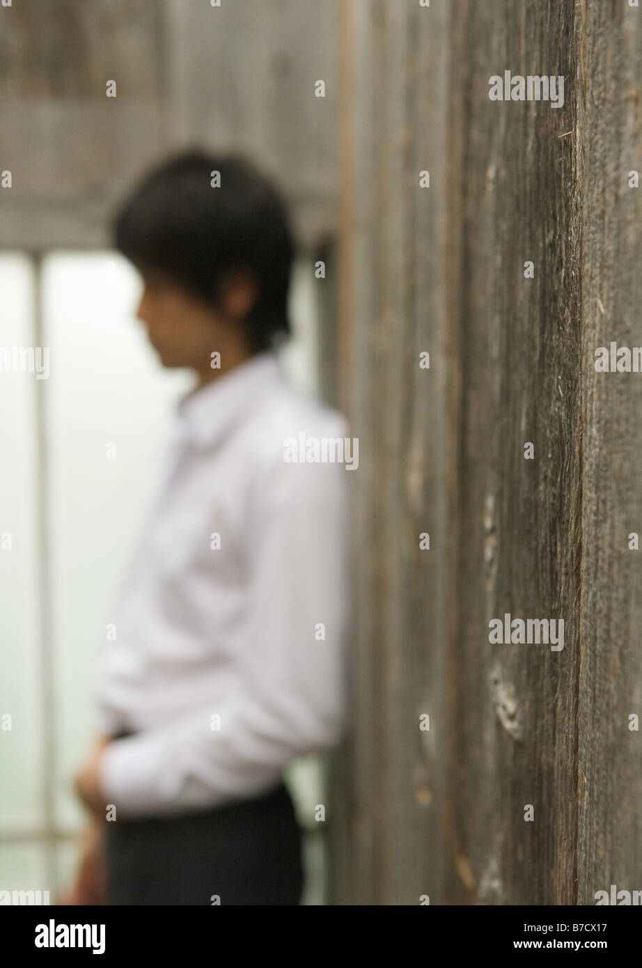 Man leaning against wall Stock Photo - Alamy
