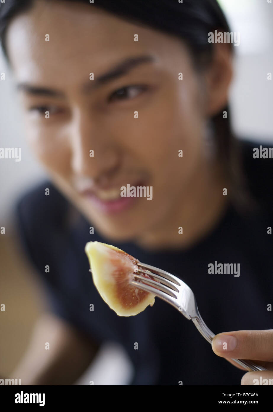Man eating fig Stock Photo - Alamy