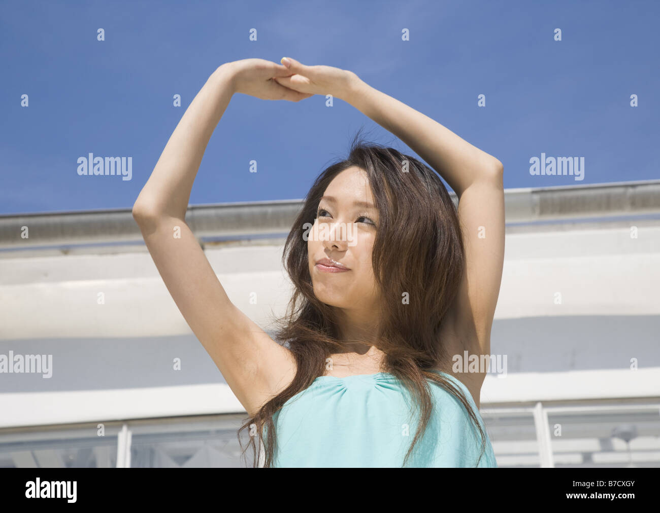 Woman stretching arms above head hi-res stock photography and images ...