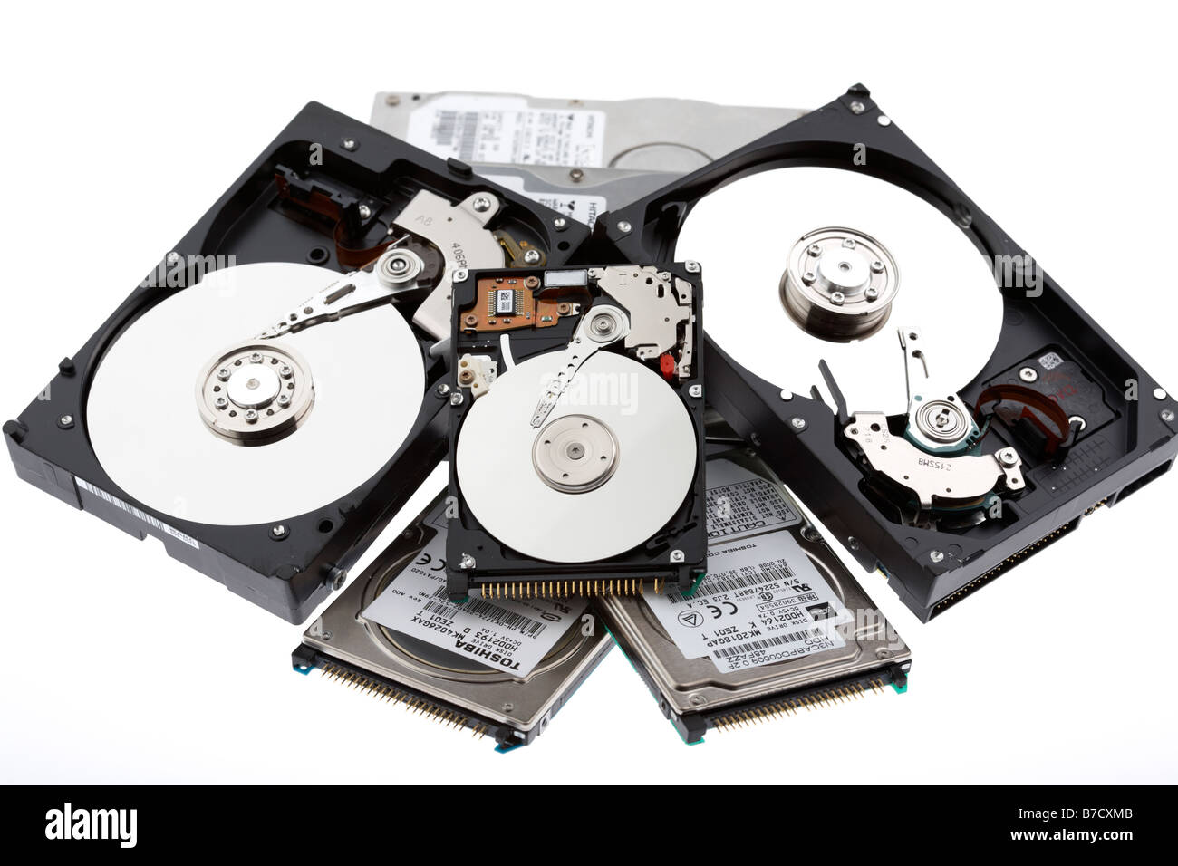 selection of open computer hard drives piled up on white background ...