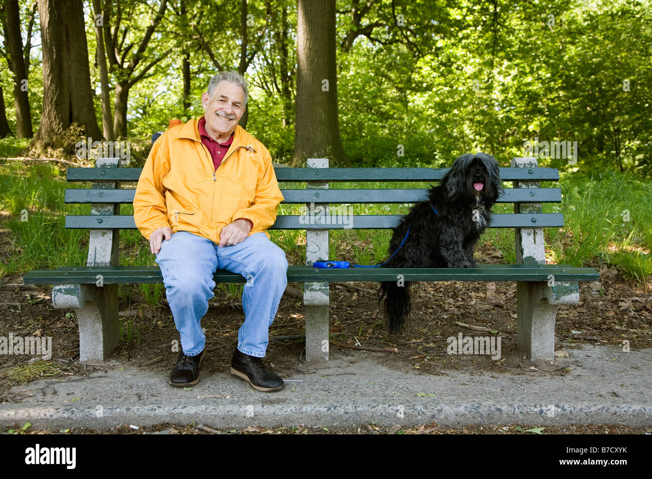 A man sitting with his dog on a park bench, Prospect Park, Brooklyn ...