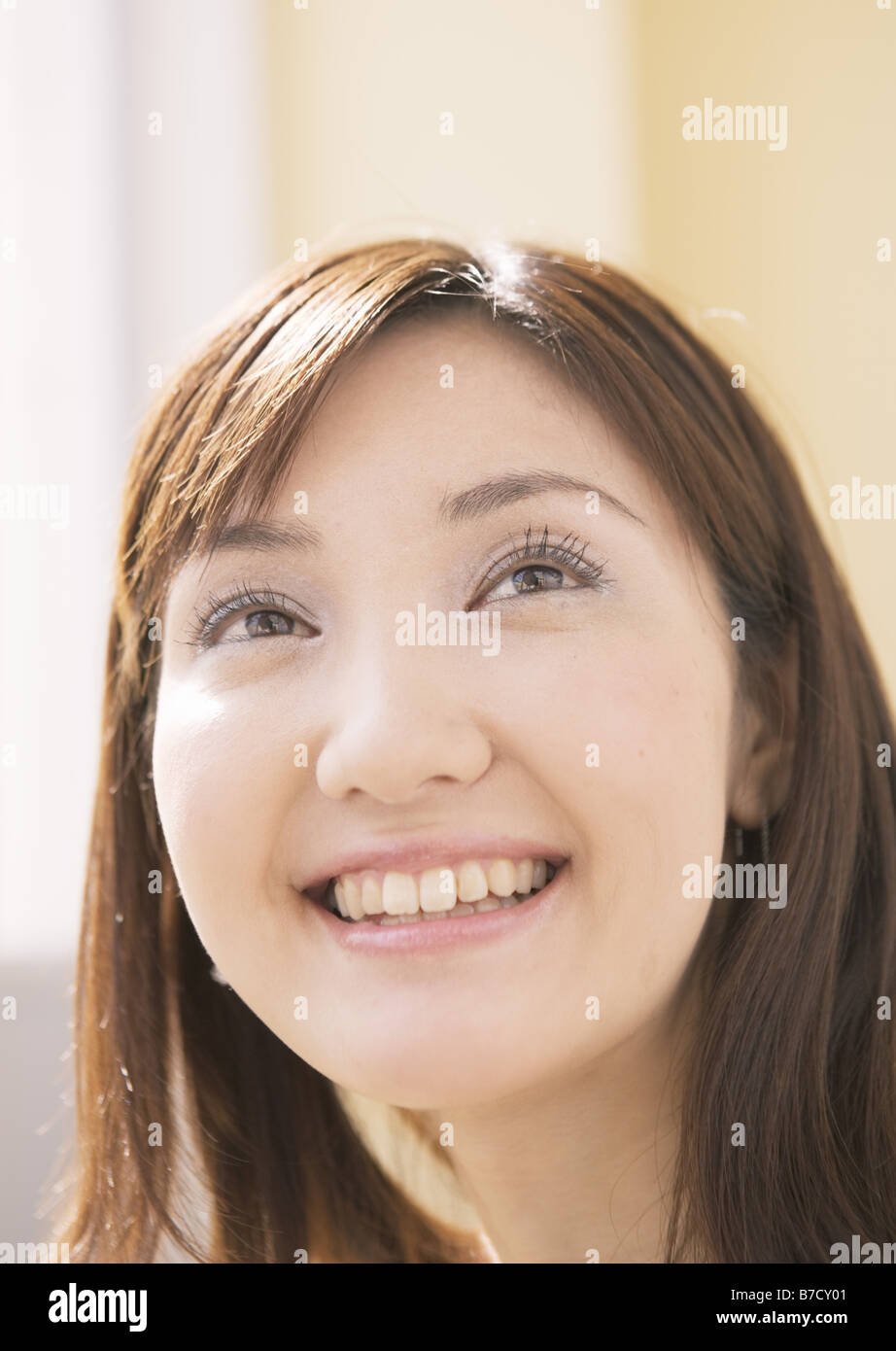 Woman with long hair smiling Stock Photo - Alamy